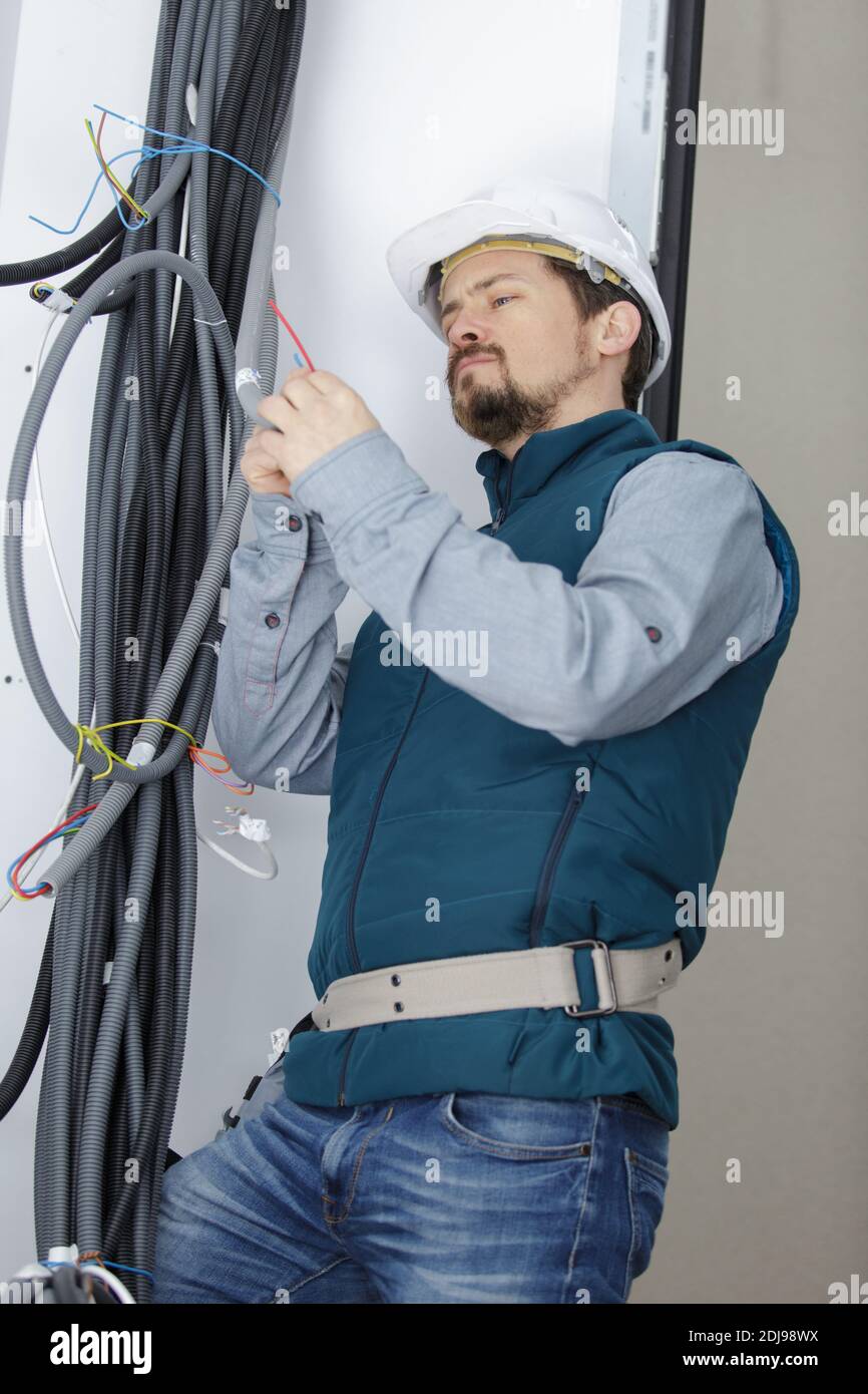 electrician engineer works with electric cable on fuse switch box Stock ...