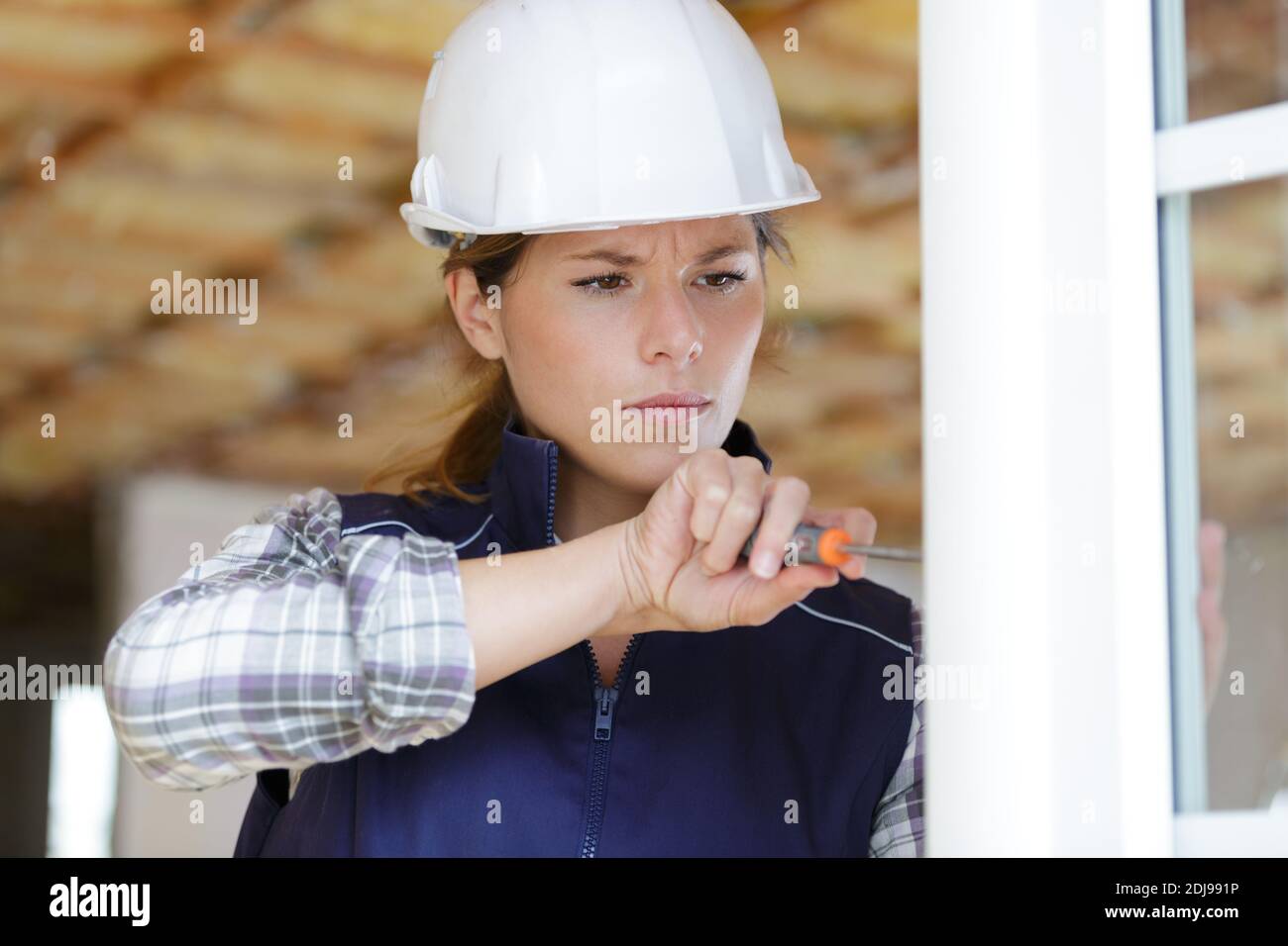 female worker installing a window Stock Photo - Alamy