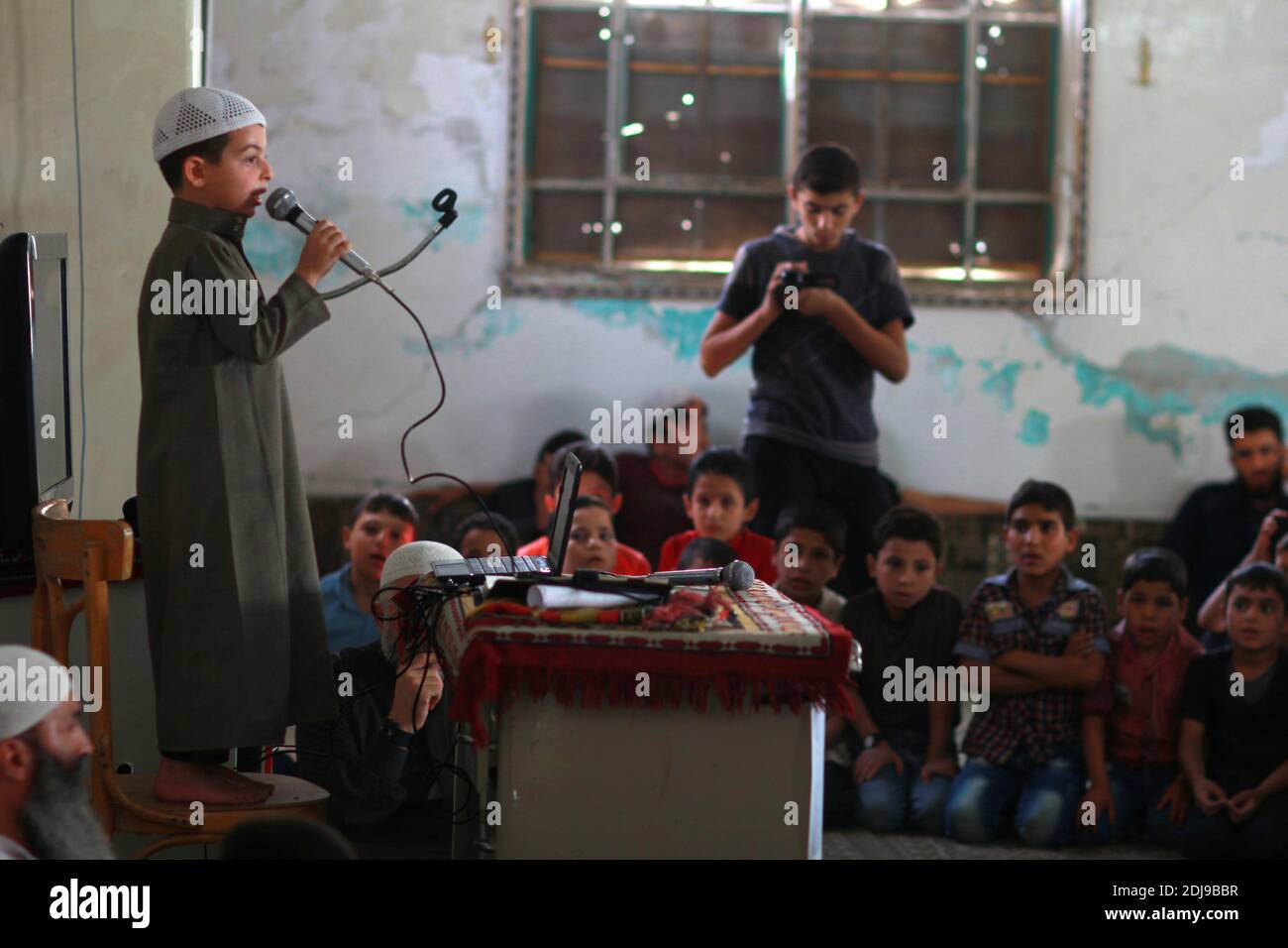 Atmosphere as young students join in a Quran learning competition, in a ...