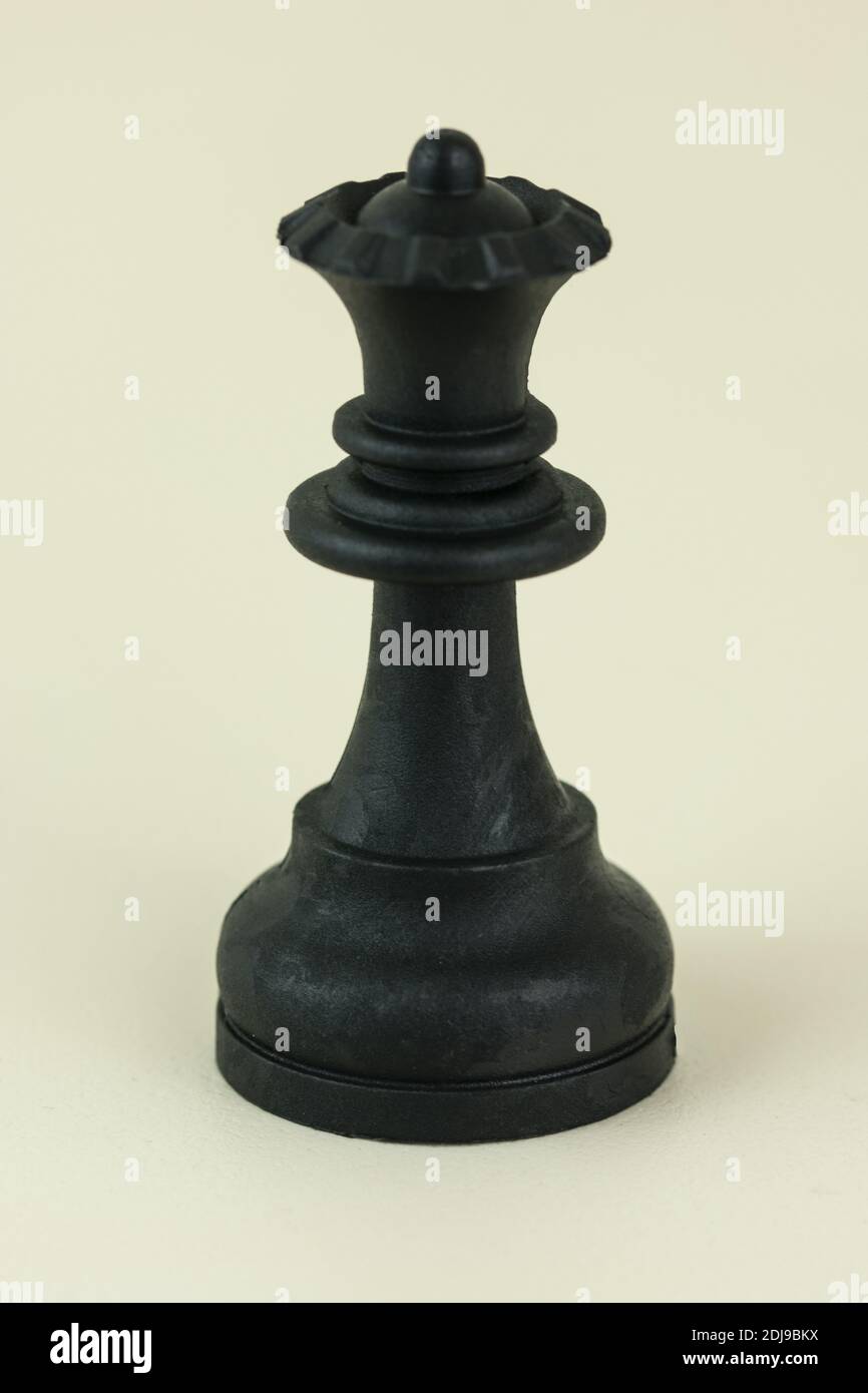 A closeup vertical shot of a chess single queen piece isolated on a ...