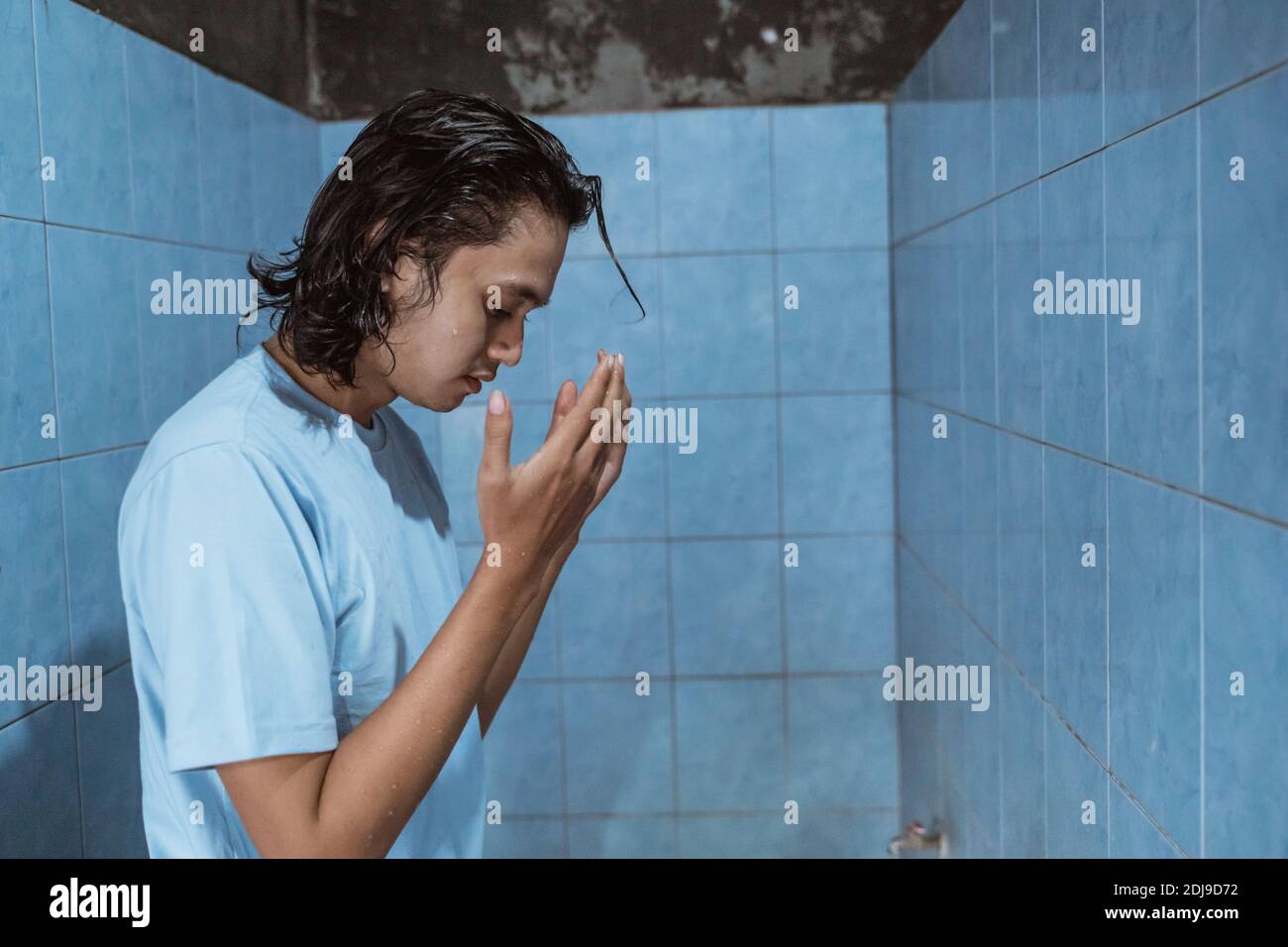 Man muslim perform ablution (wudhu) washing ear before prayer Stock ...