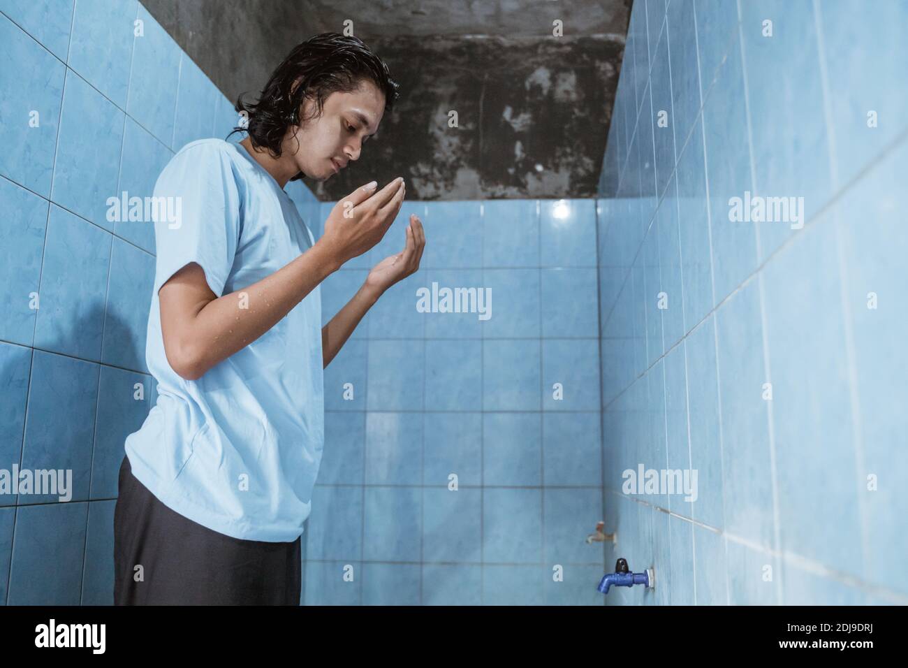 Man muslim perform ablution (wudhu) washing ear before prayer Stock ...