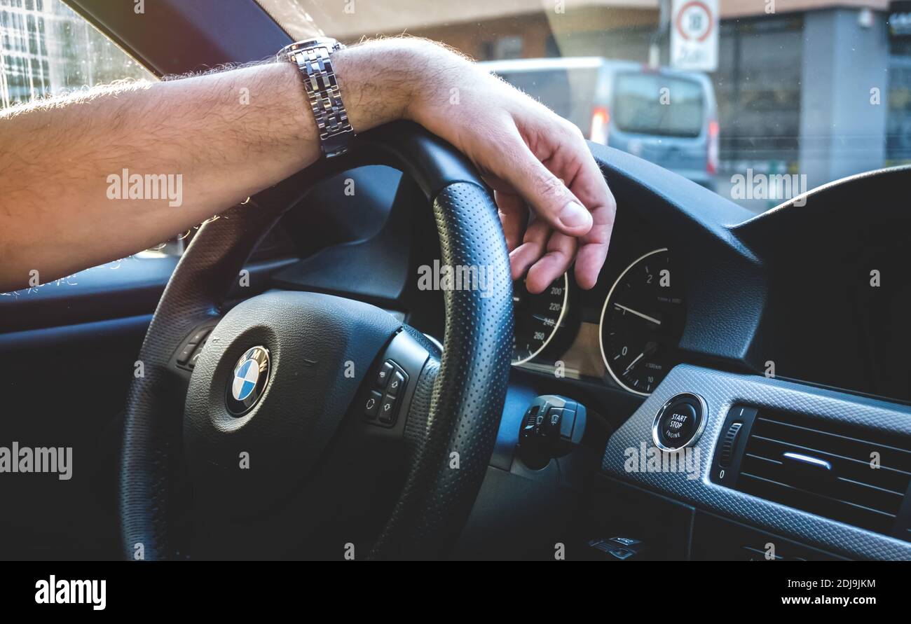Vienna Austria June.5 2020. Mans hands on a steering wheel driving BMW ...