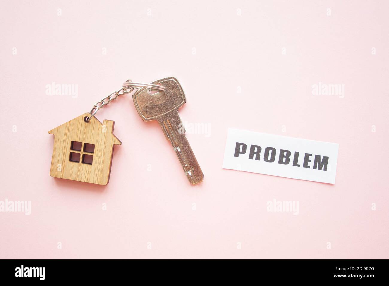 Wooden house toy and silver key on bright pink Stock Photo - Alamy