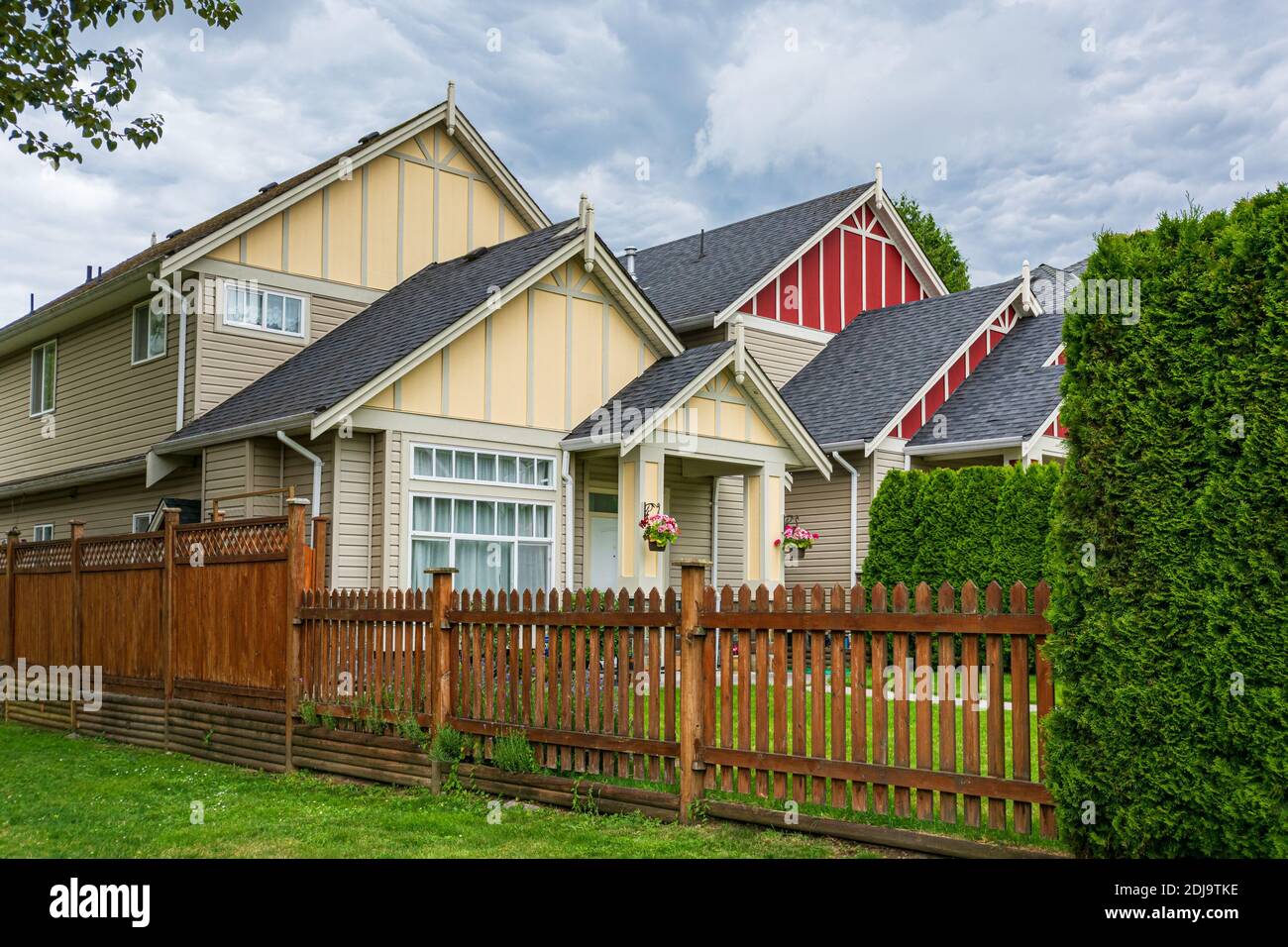 A perfect neighbourhood. Colorful residential houses with wooden fence ...