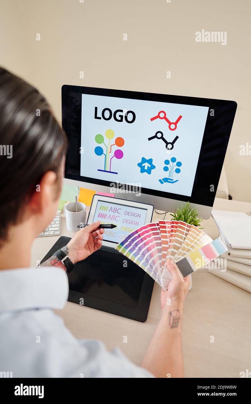 Graphic designer with color palette in hands creating company logo ...
