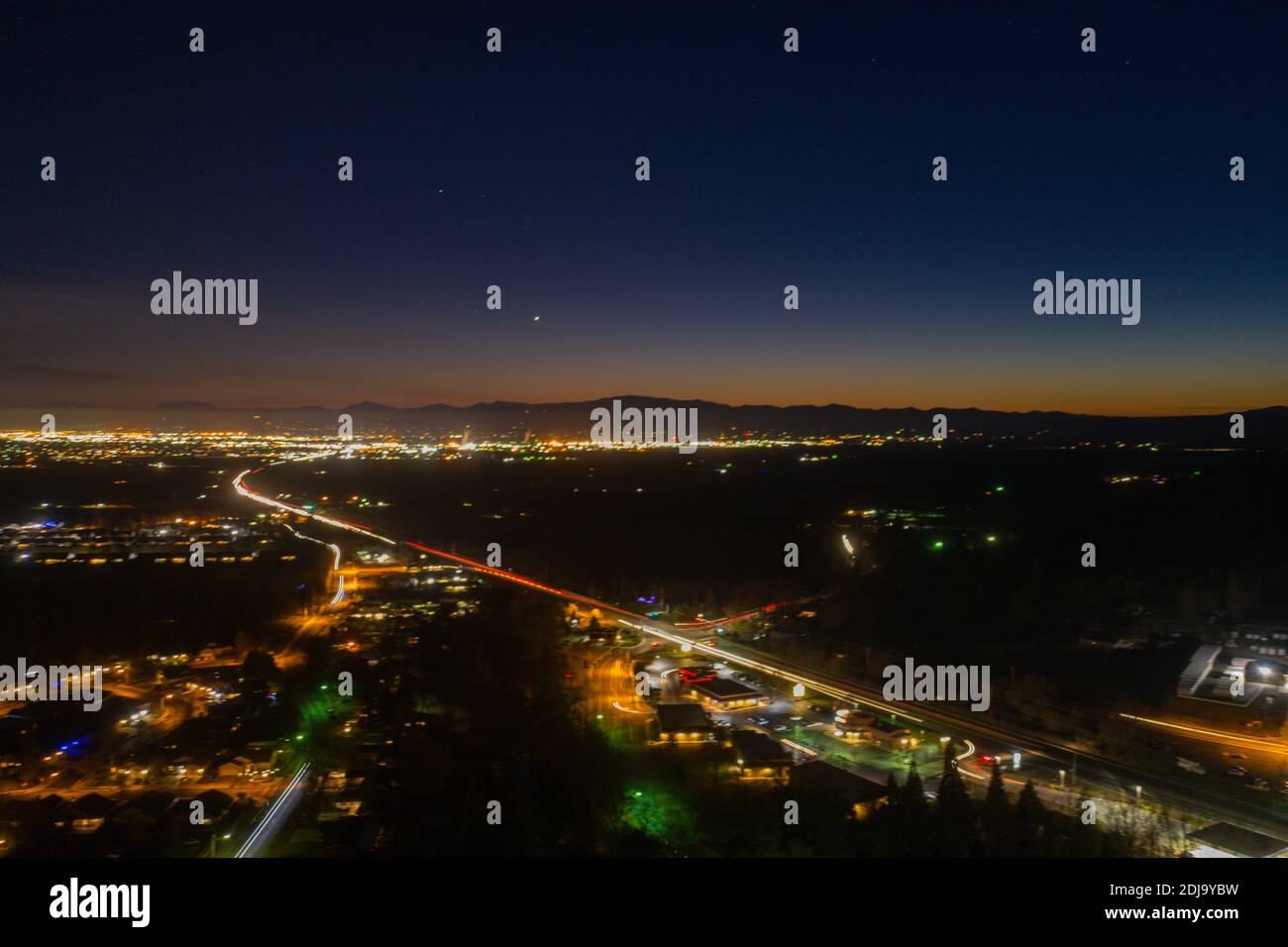 Dark small town at night with mountains as background Stock Photo - Alamy