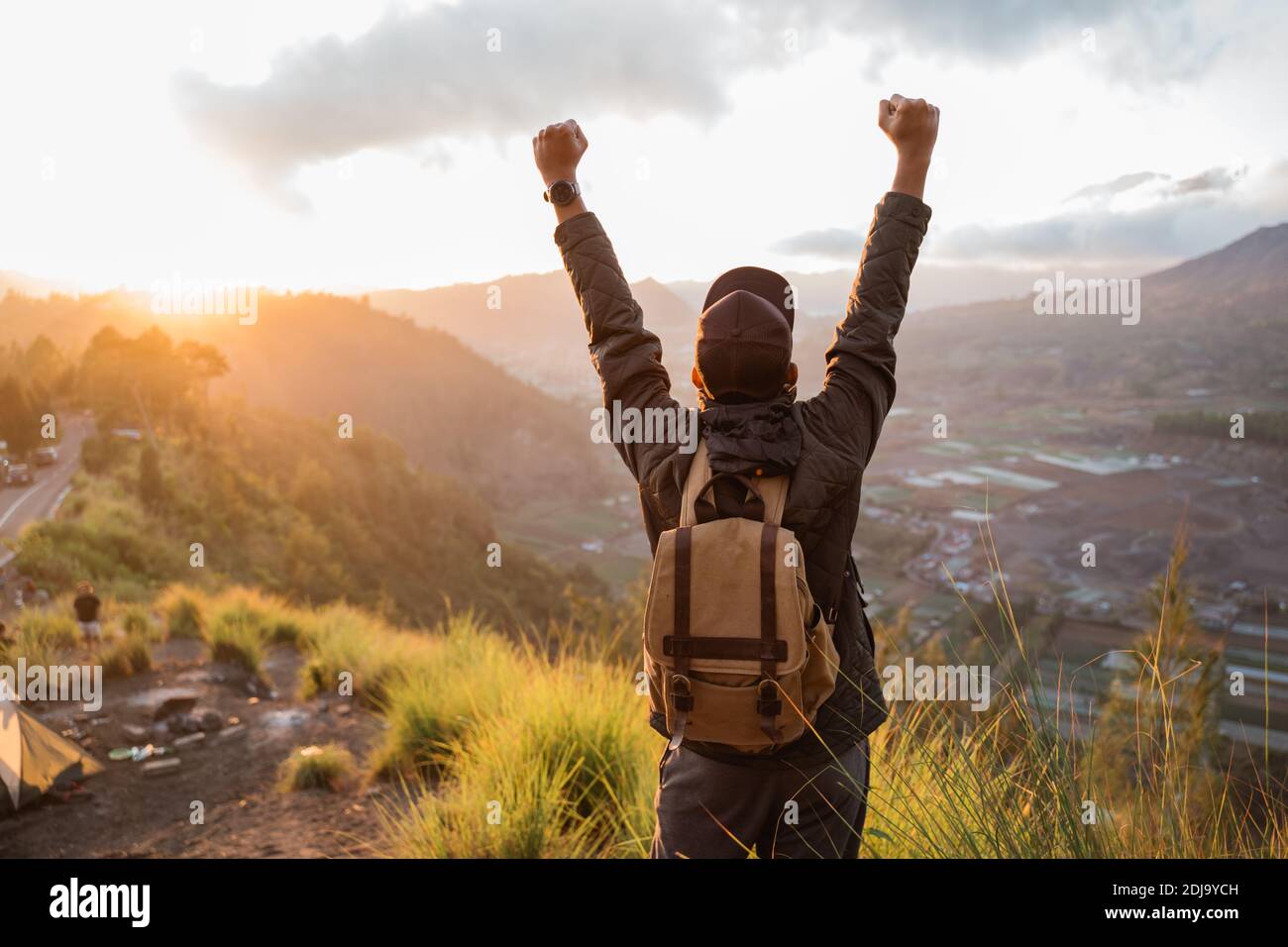 Portrait adventurous man with a backpack enjoying the mountain scenery ...