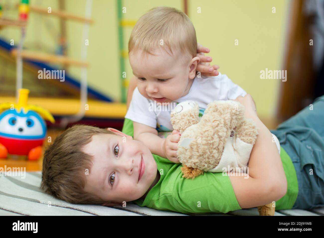 Two little brothers are playing on the carpet Stock Photo - Alamy