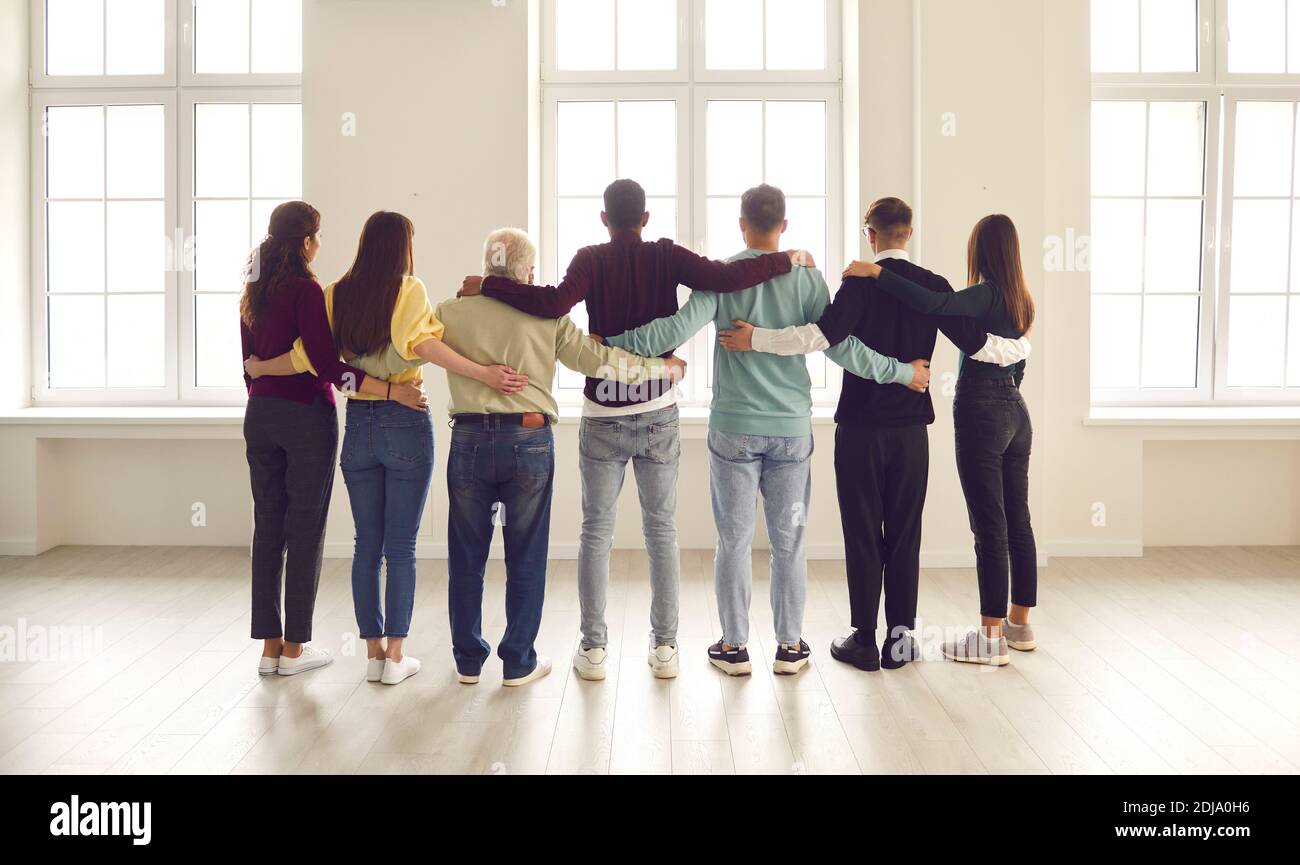 Team of community members and friends supporting each other and facing ...