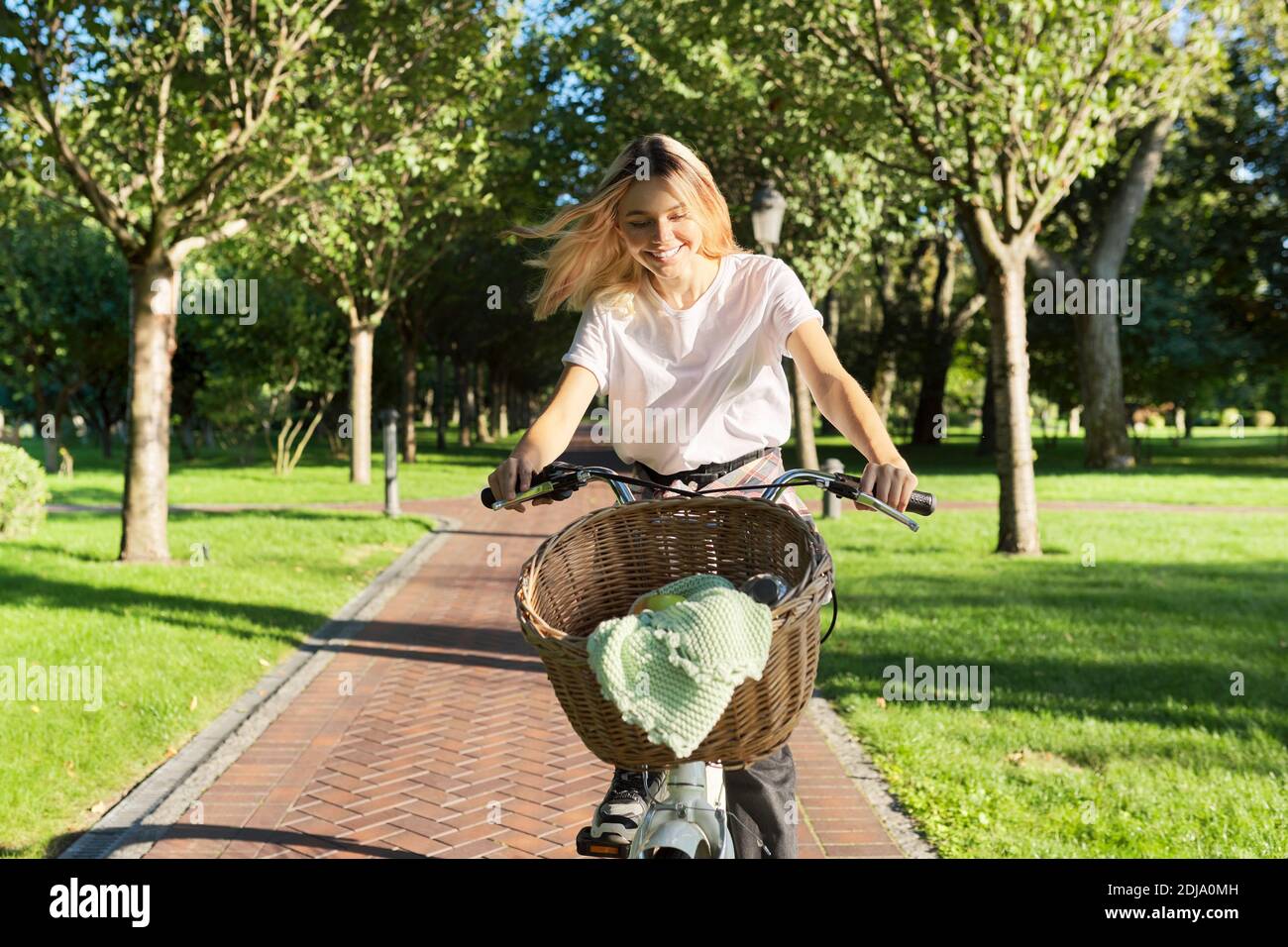Young beautiful woman on vintage bike with basket rides on nature Stock ...
