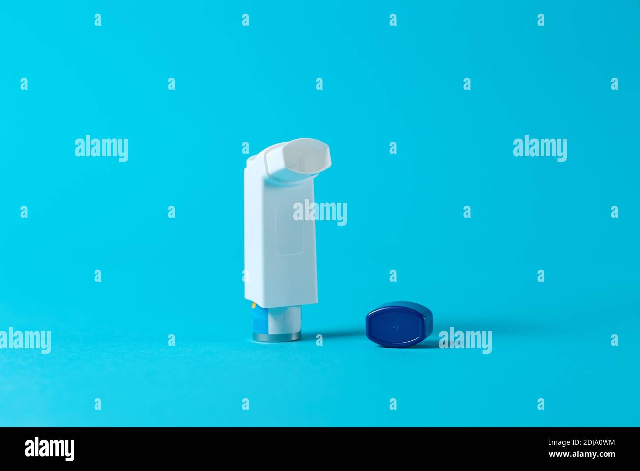 Treatment of asthma. An open inhaler with medicine stands next to the ...