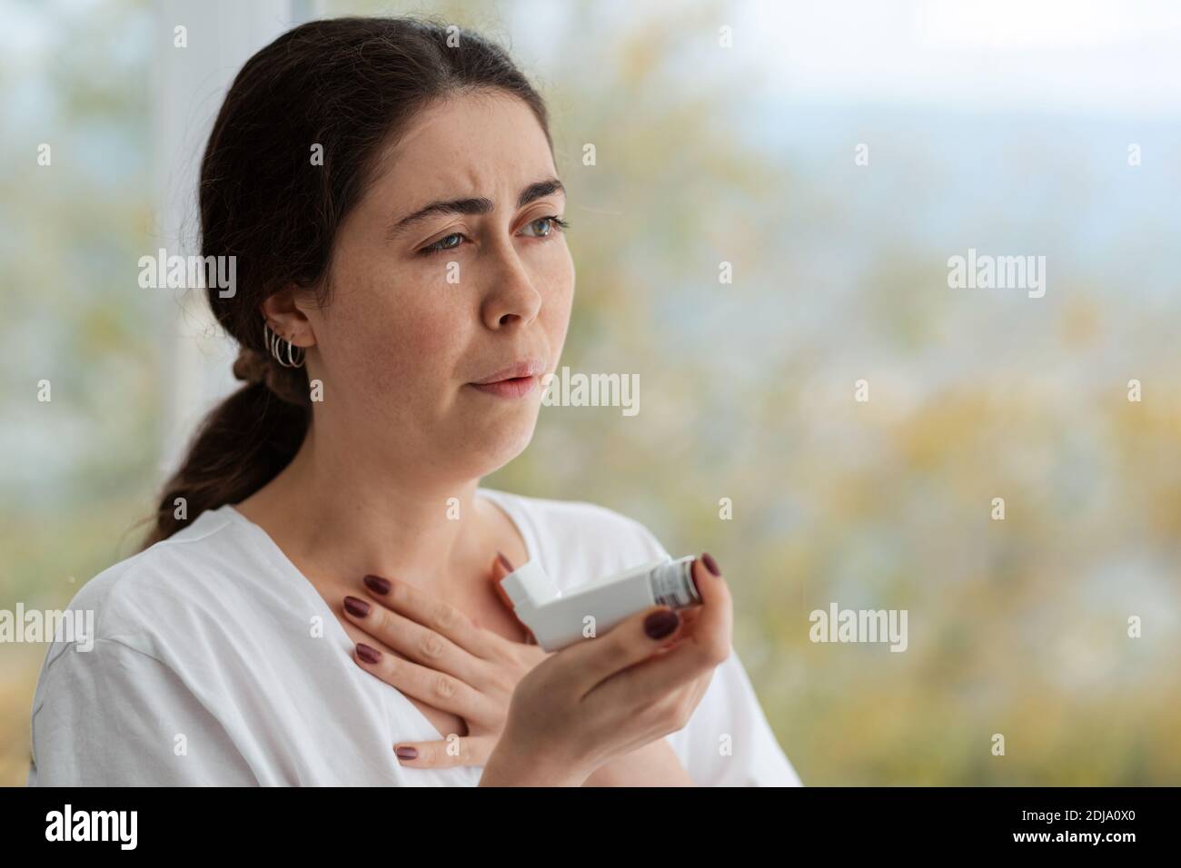 Allergic Asthma. Portrait of a woman experiencing an asthmatic attack ...