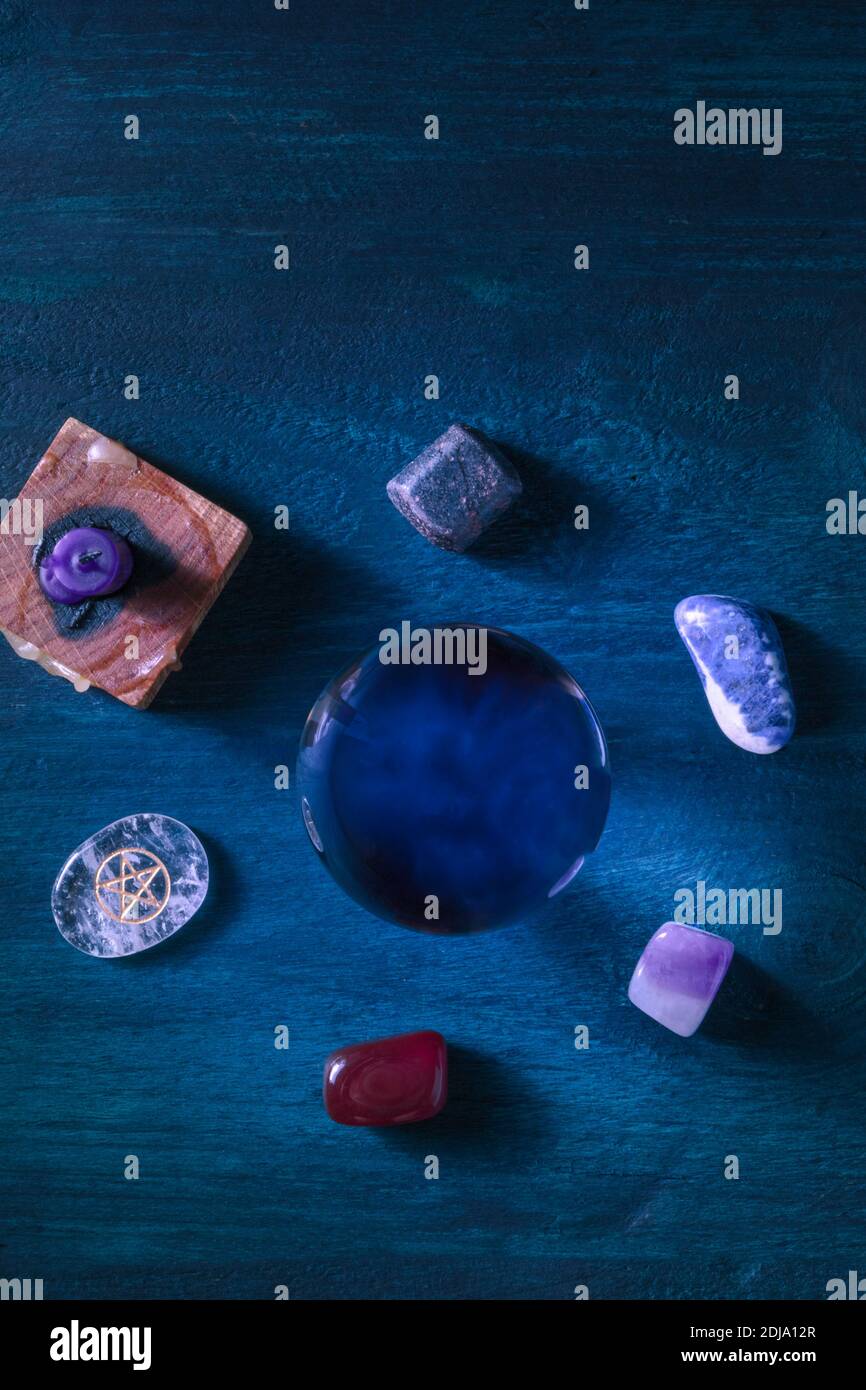 Fortune telling. A magic ball, overhead flat lay shot with crystals and ...