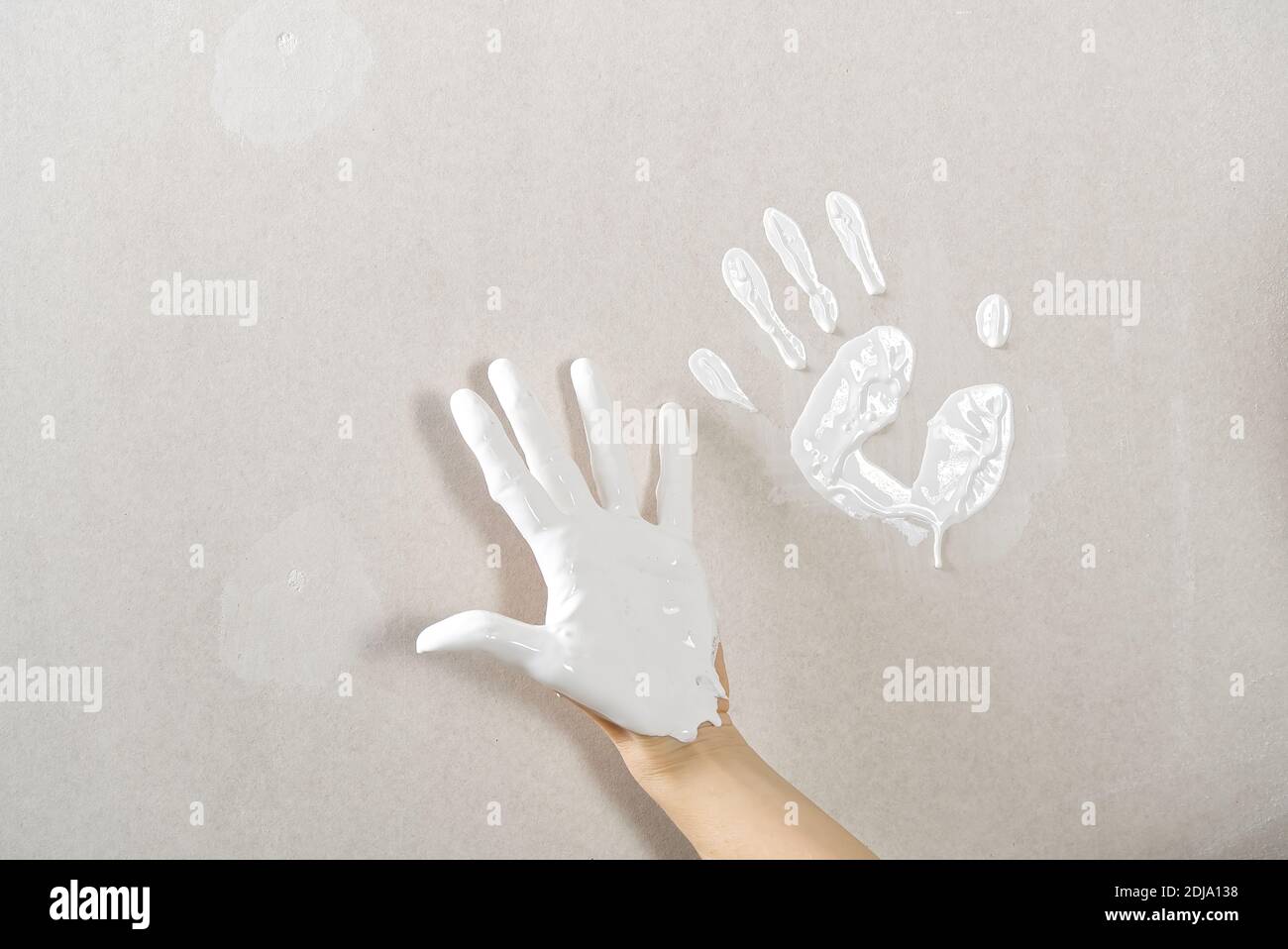 Hand print made with white paint on drywall. painter have fun Stock ...