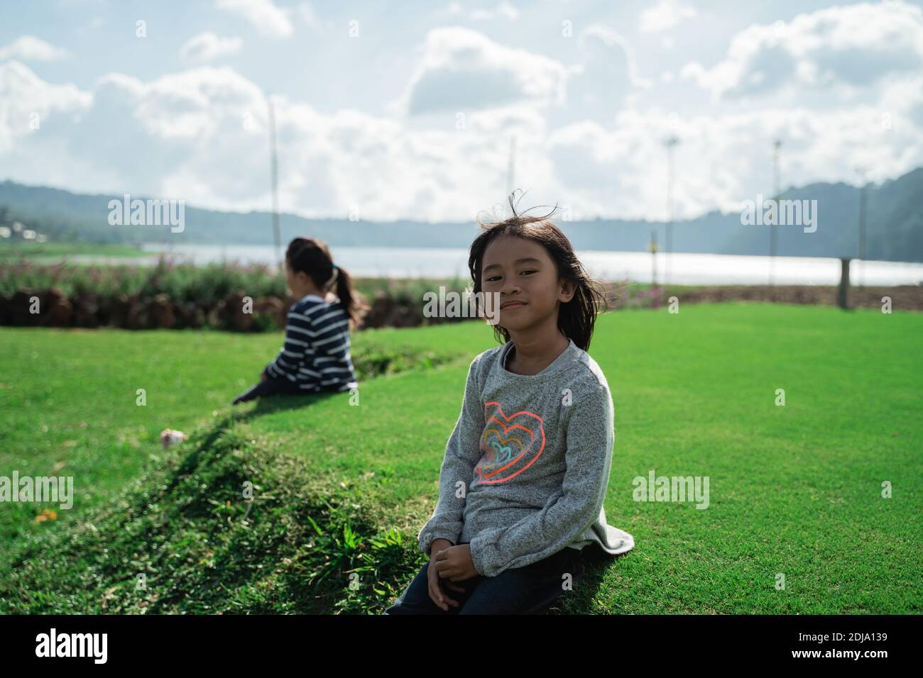 Portrait little girl enjoying the beautiful hill scenery Stock Photo ...