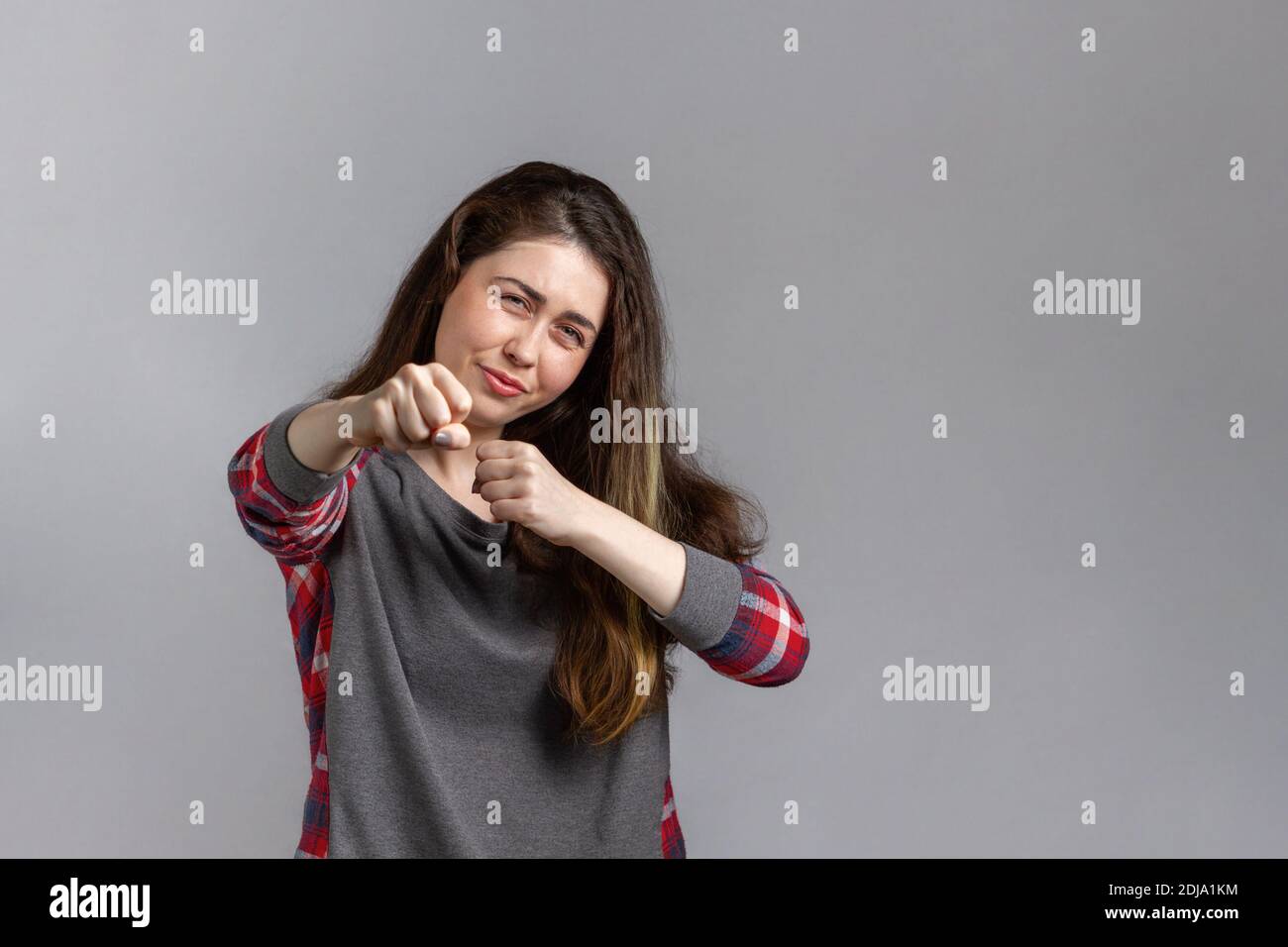 Emotions. A young woman with a disgruntled face aggressively shows her ...