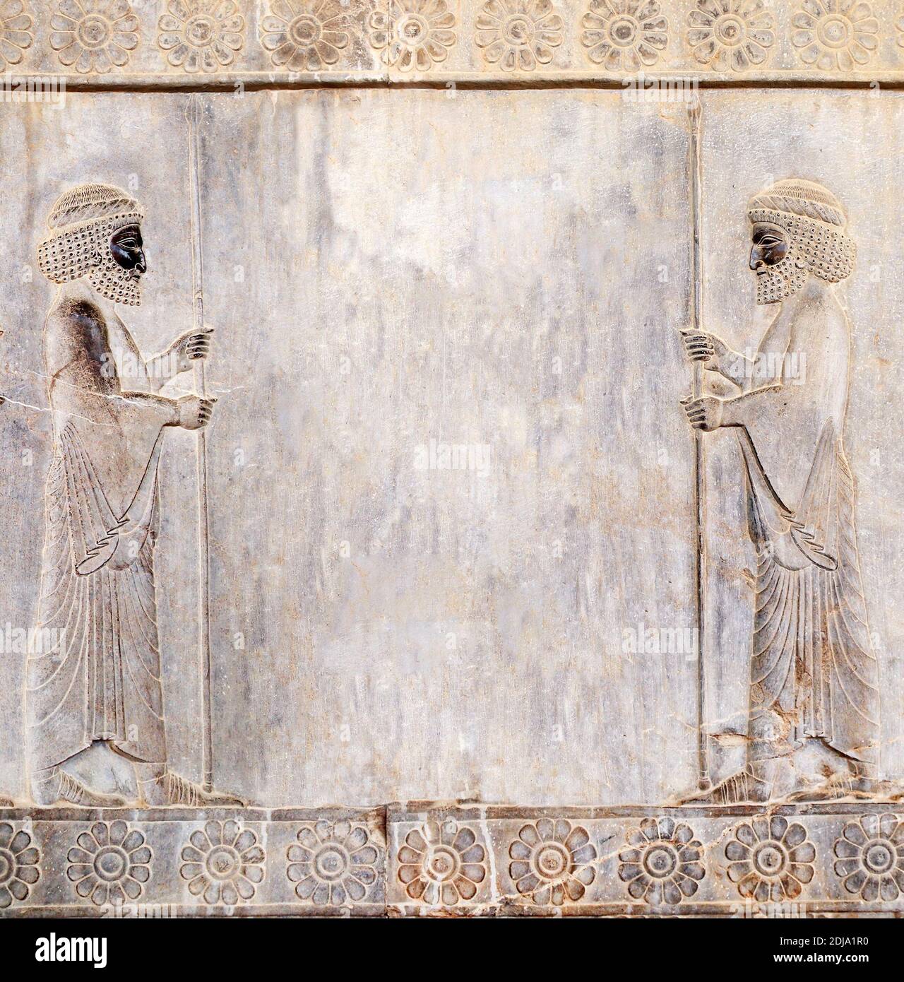 Ancient wall with bas-relief - two assyrian warriors with spears ...