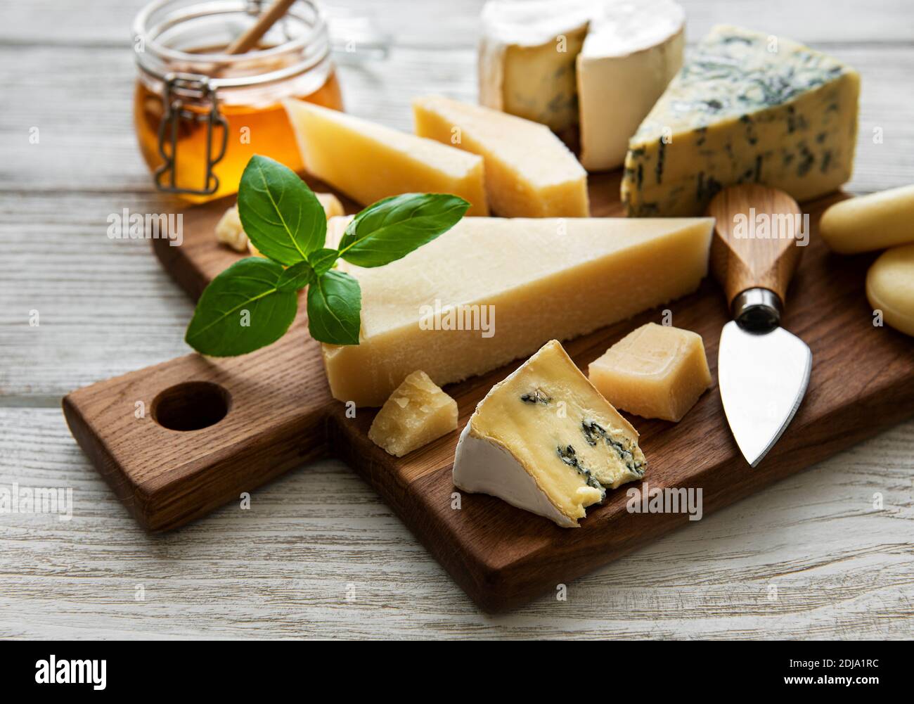 Various types of cheese on a white wooden background Stock Photo - Alamy