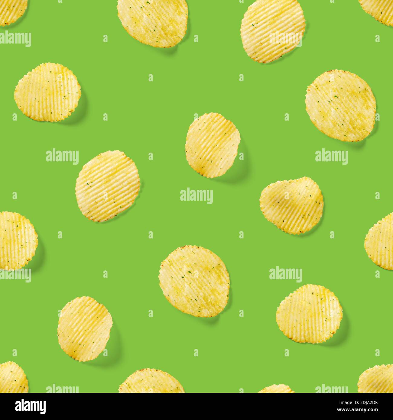 Seamless pattern made from Potato chips on green background flat lay ...
