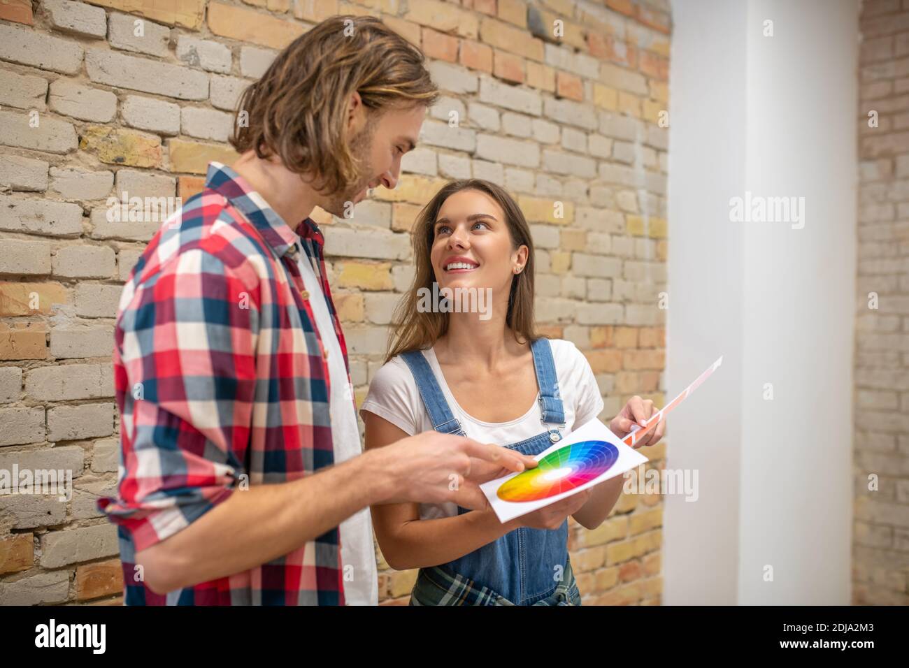 Young couple looking at color palette and choosing the wall color Stock ...