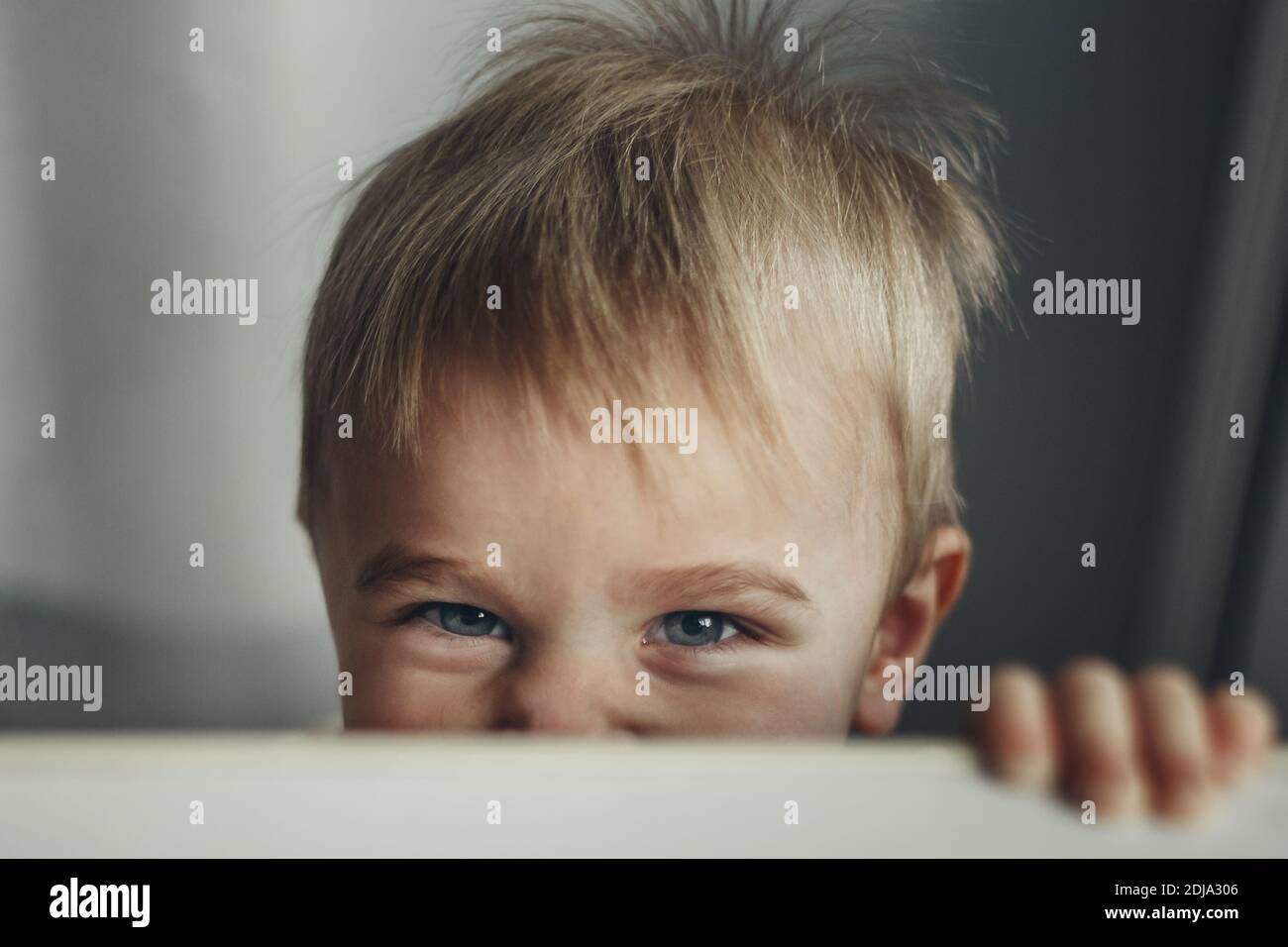 Boy peeking table hi-res stock photography and images - Alamy