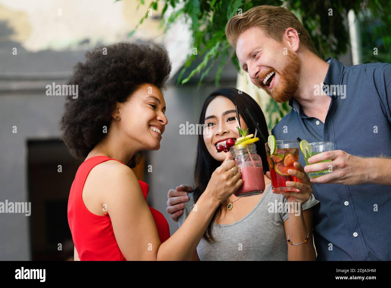 Diverse group of happy friends having fun, talking in cafe outdoor at ...