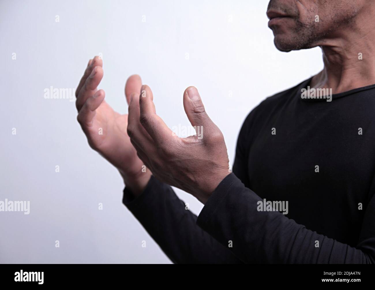 man praying to god with hands together Caribbean man praying with grey ...