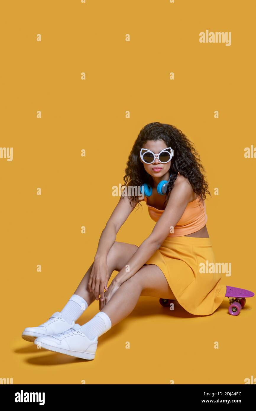 Pretty Dark Haired Young Girl With A Skateboard And Sunglasses Stock