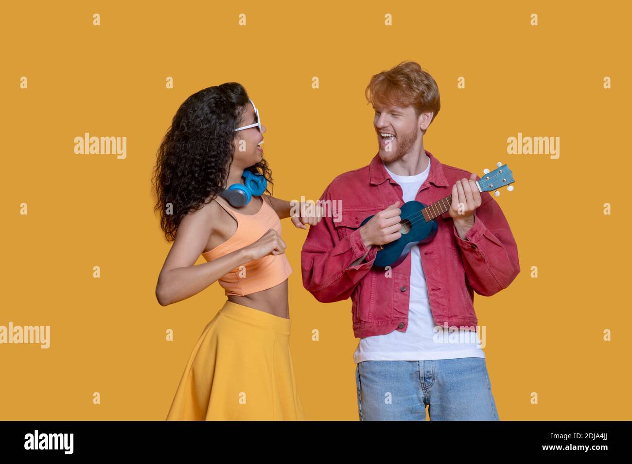 Good-looking young couple having fun and dancing Stock Photo - Alamy