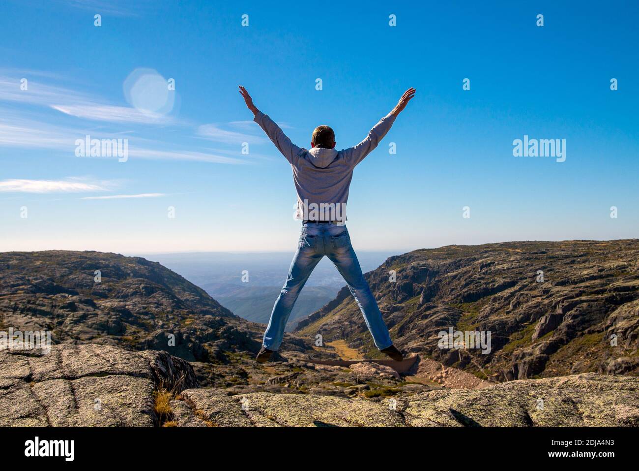 Happy Man jumping at mountains to clouds sky Lifestyle Travel emotional ...