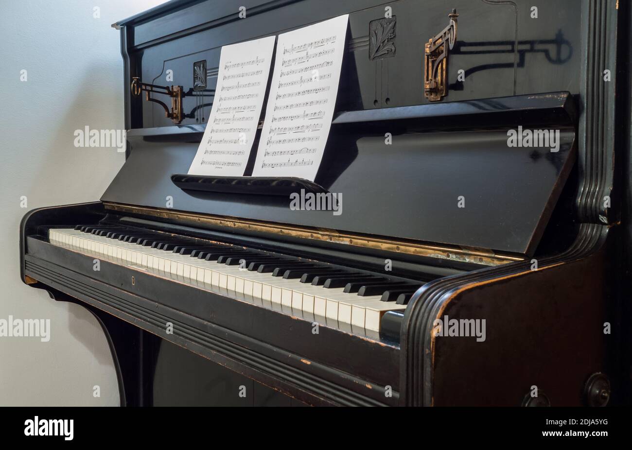 Musical notes on old black piano composer Stock Photo - Alamy