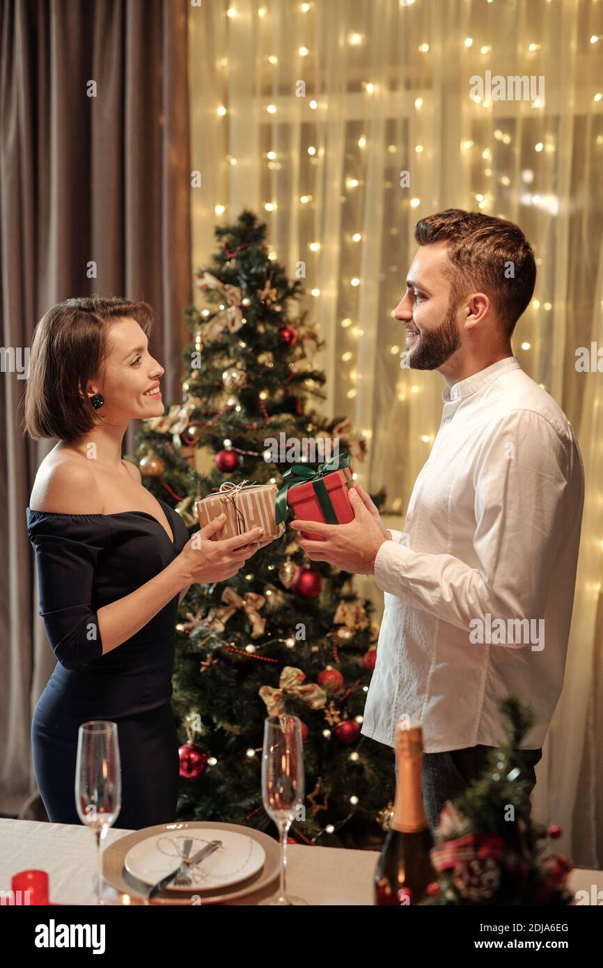 Positive beautiful young couple standing opposite each other ready to ...