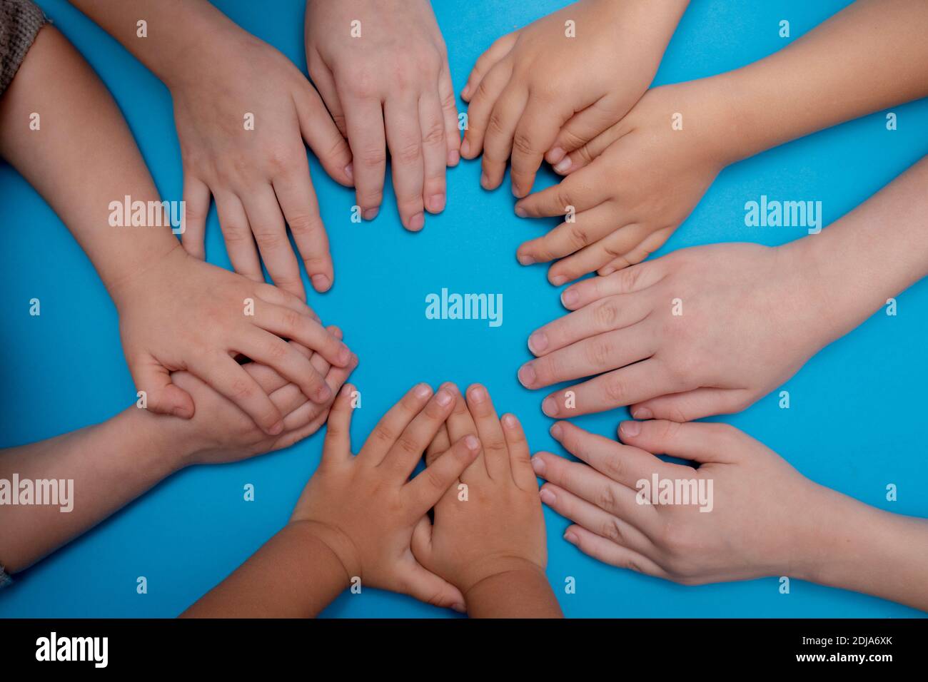 Five children putting their hands together, flat lay. Happy family ...