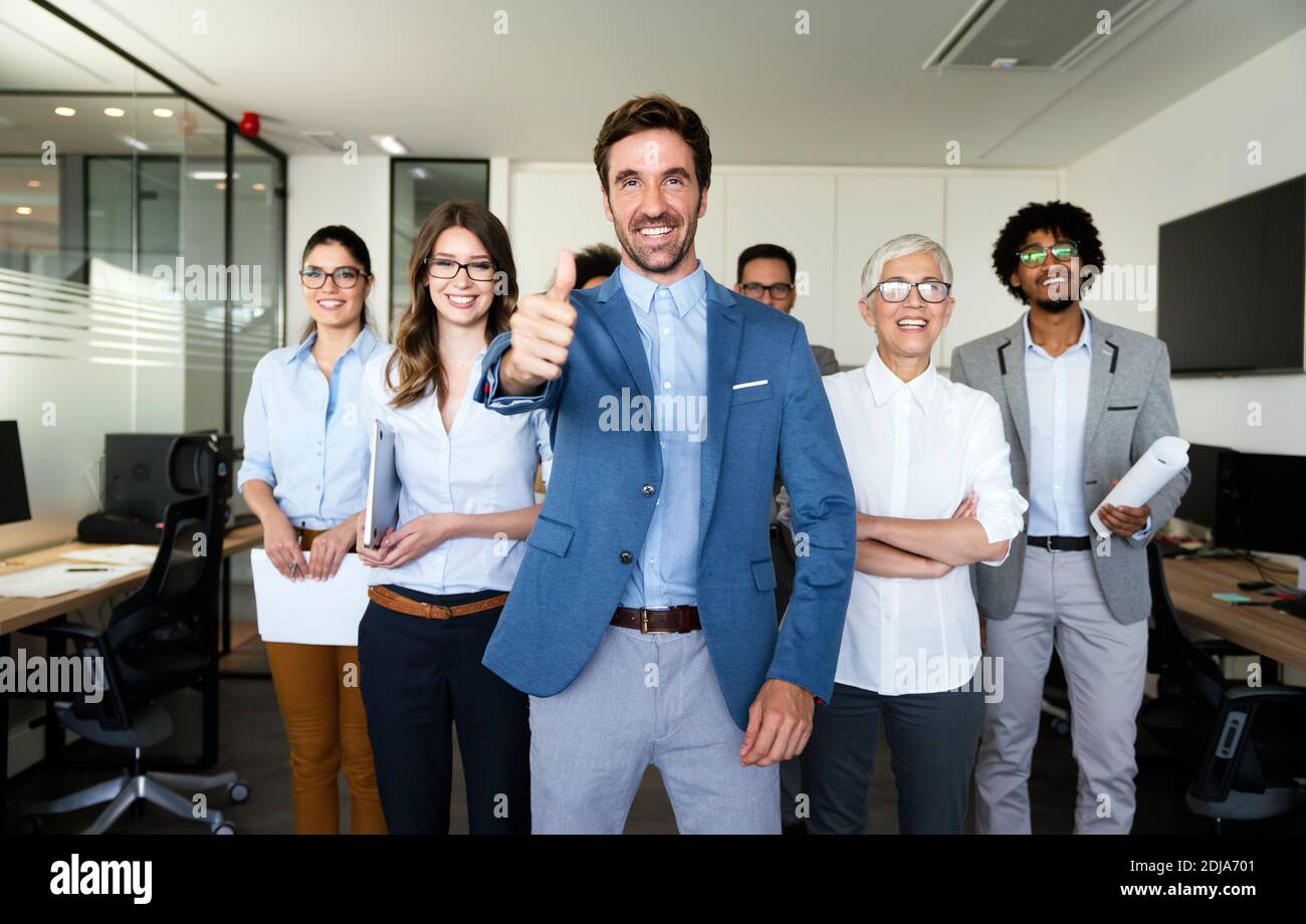 Happy business people celebrating success at company Stock Photo - Alamy