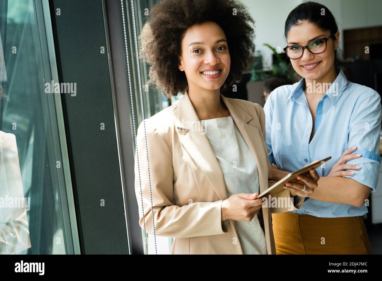 Portrait of successful business women colleagues using digital tablet ...