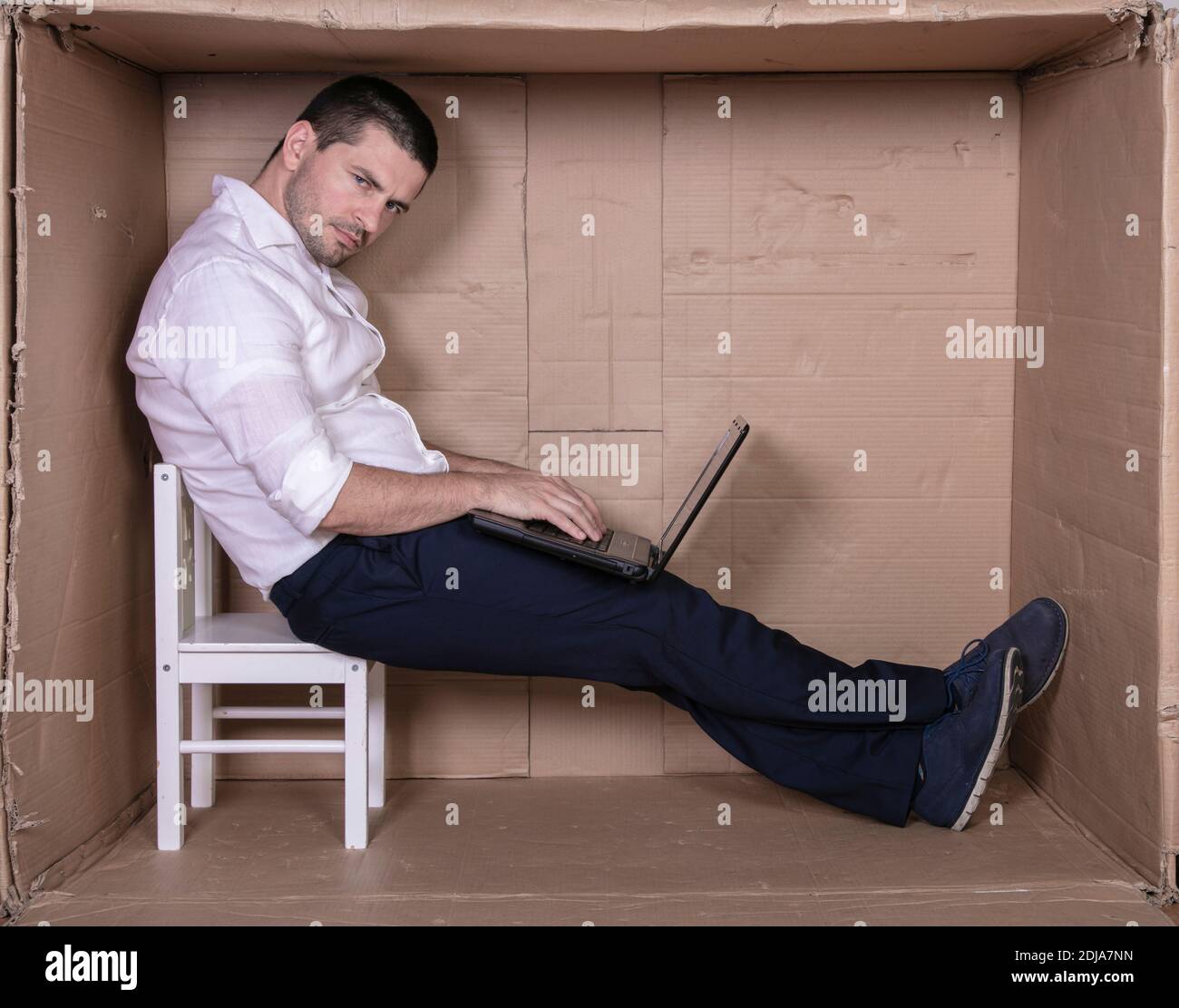 broken businessman in a cardboard office, stress and depression from ...
