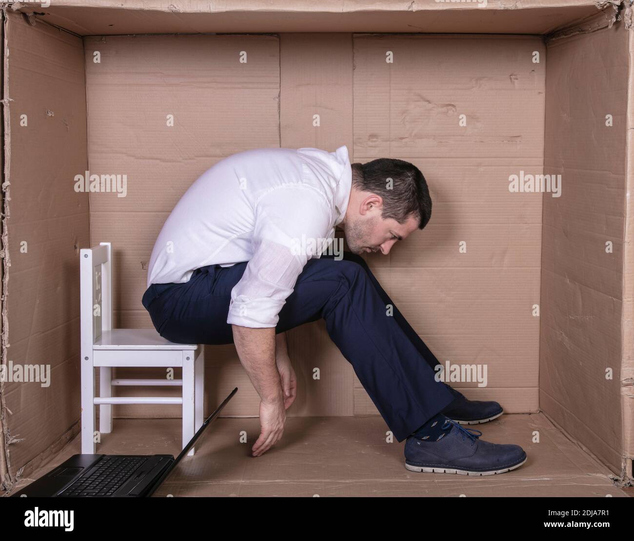 broken businessman in a cardboard office, stress and depression from ...