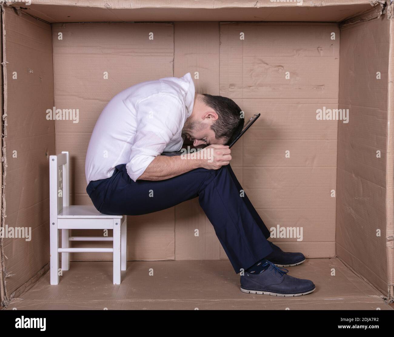 broken businessman in a cardboard office, stress and depression from ...