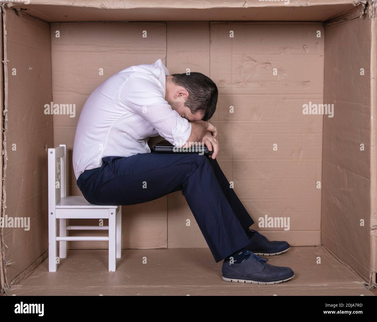 broken businessman in a cardboard office, stress and depression from ...