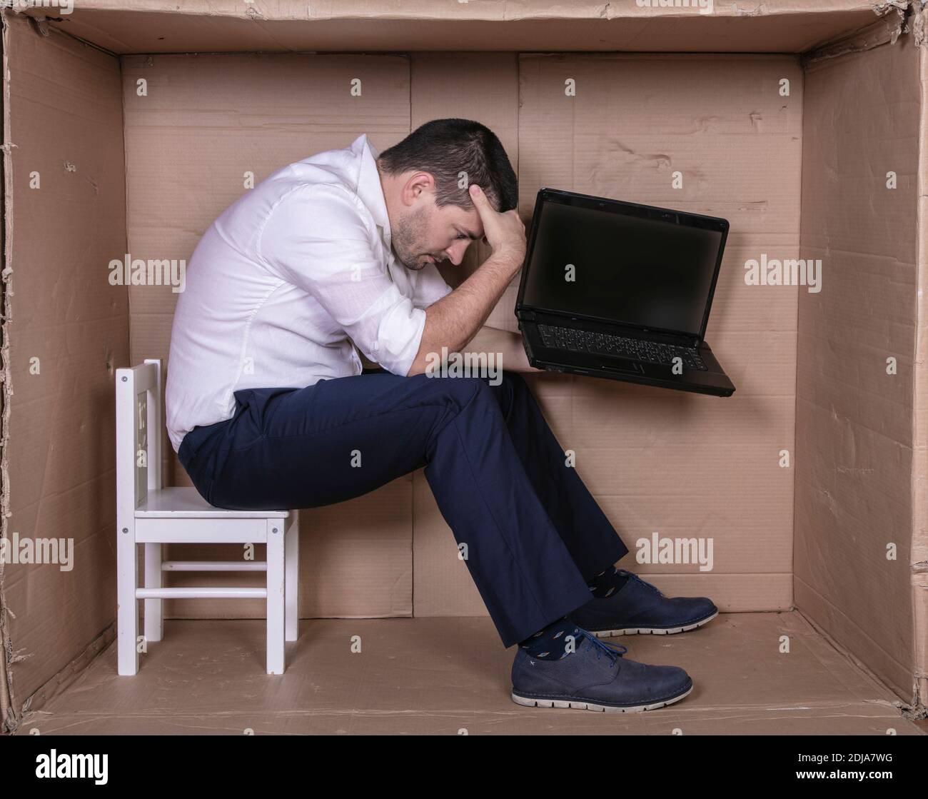 broken businessman in a cardboard office, stress and depression from ...