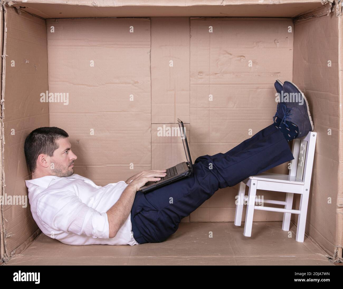 broken businessman in a cardboard office, stress and depression from ...