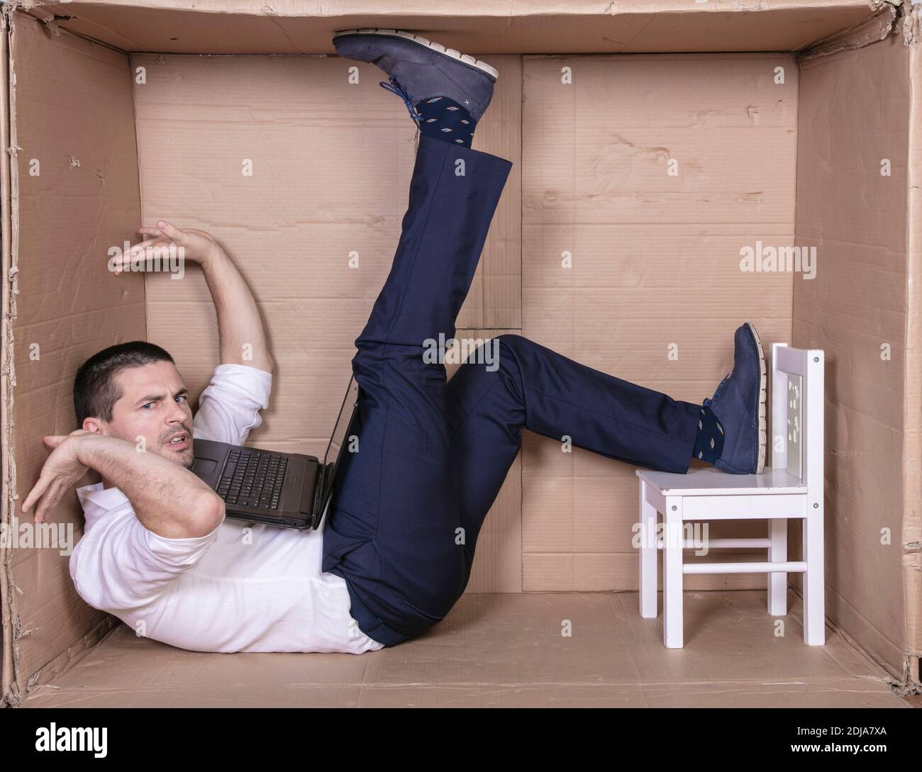 broken businessman in a cardboard office, stress and depression from ...