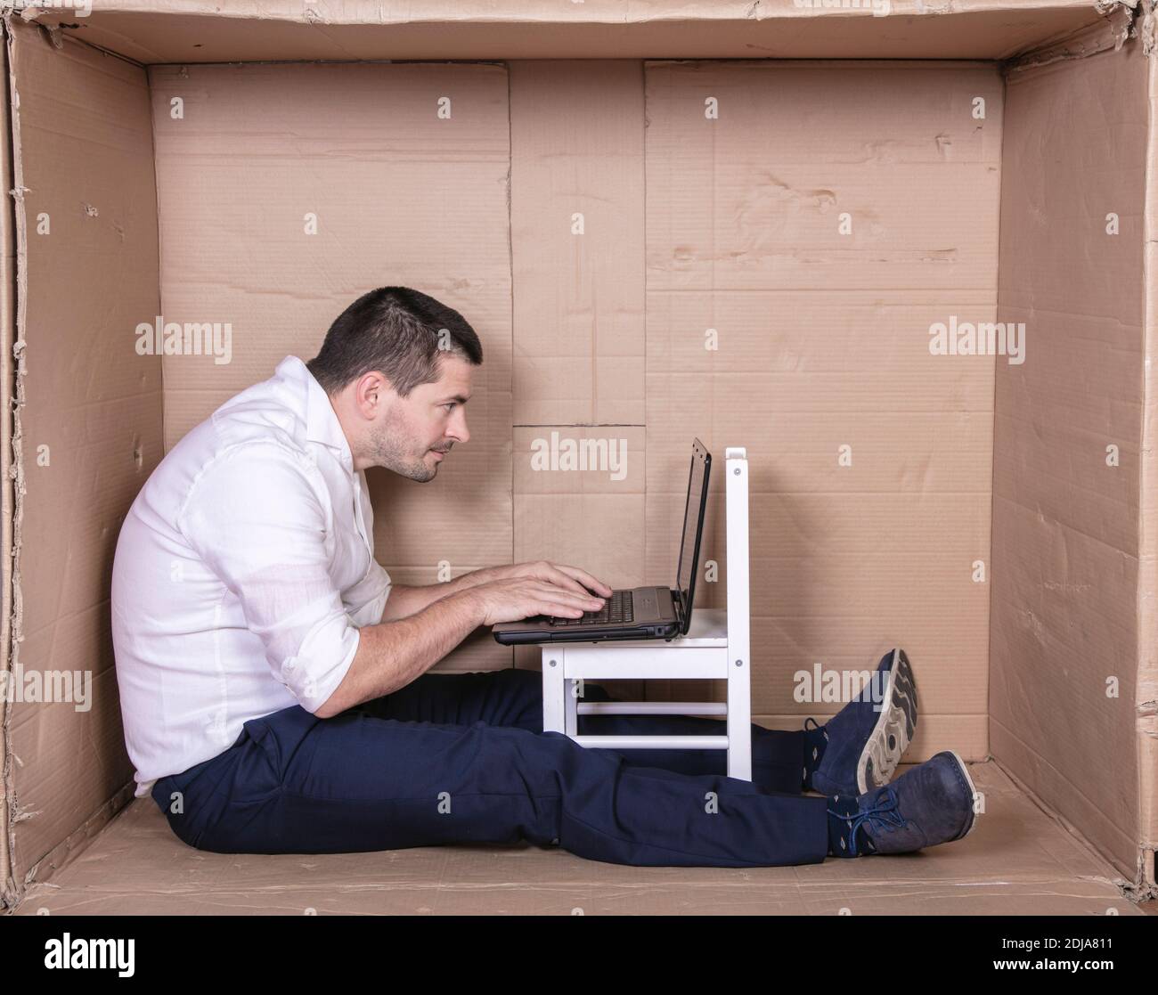 broken businessman in a cardboard office, stress and depression from ...