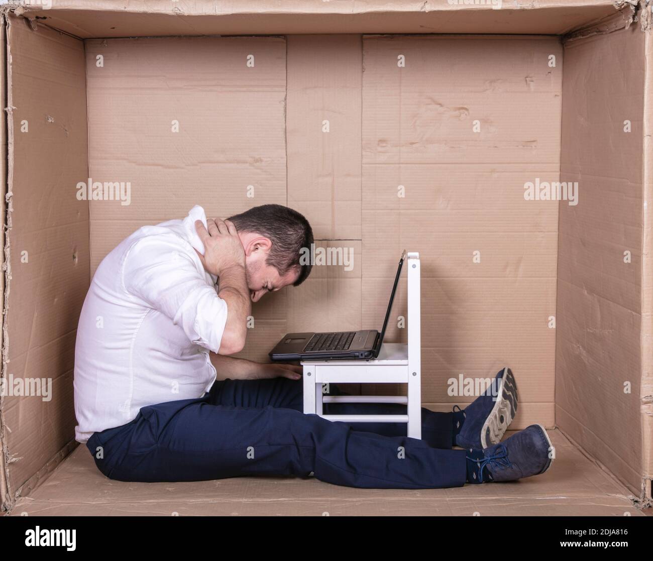 broken businessman in a cardboard office, stress and depression from ...