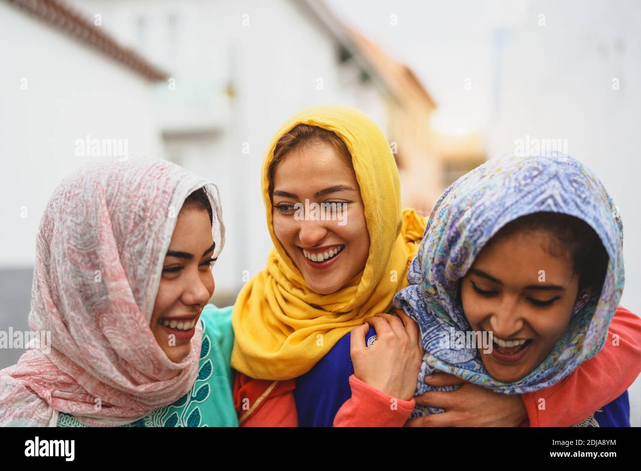 Happy Muslim women walking in the city center - Arabian young girls ...