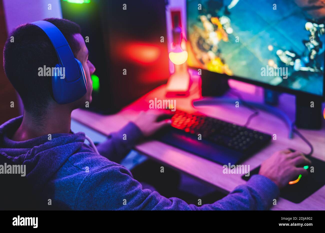 Young gamer playing online video games while streaming on social media ...