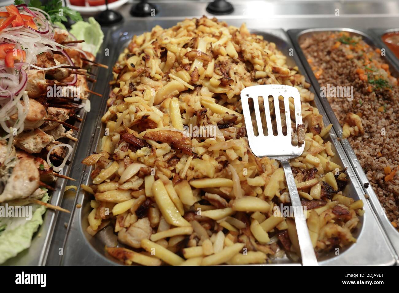 Tray with fried potatoes on a buffet Stock Photo - Alamy