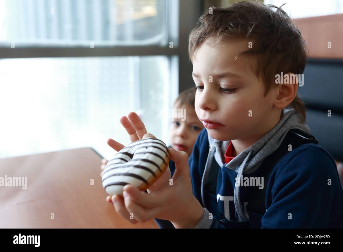 Child eat donut hi-res stock photography and images - Alamy