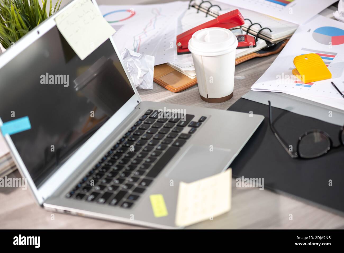Messy and cluttered office desk Stock Photo - Alamy